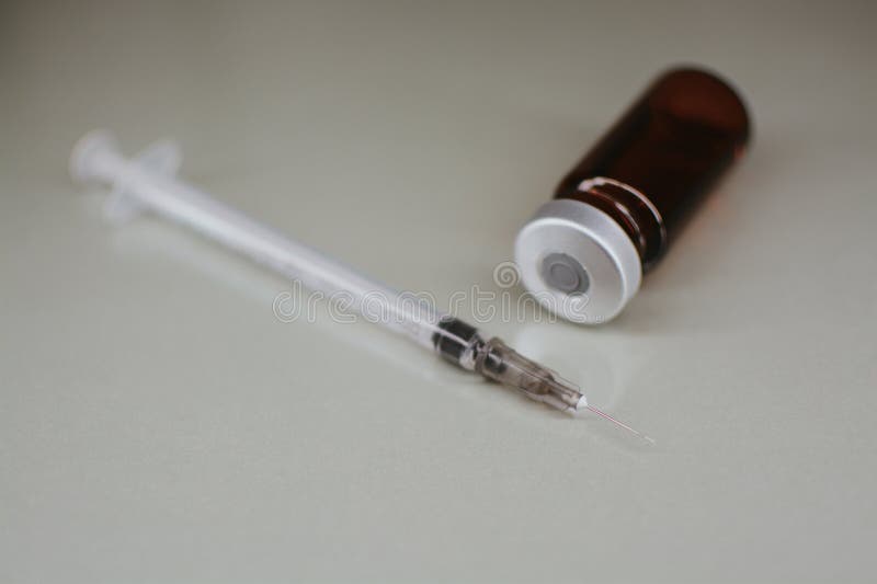A Syringe with a Thin Sharp Needle and an Ampoule with a Therapeutic ...