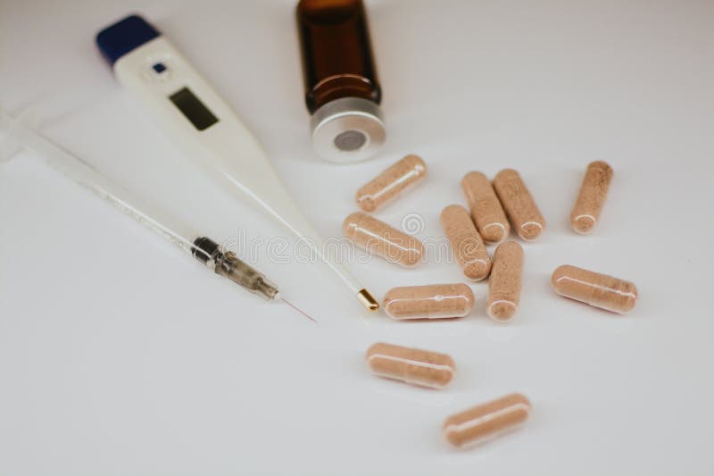 A Syringe with a Thin Sharp Needle, an Injection Ampoule, a Thermometer ...