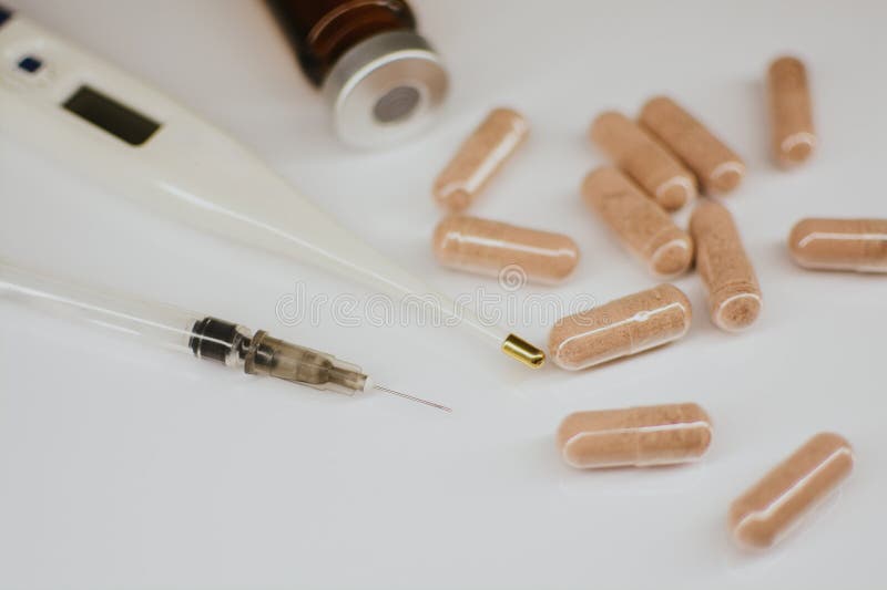 A Syringe with a Thin Sharp Needle, an Injection Ampoule, a Thermometer ...