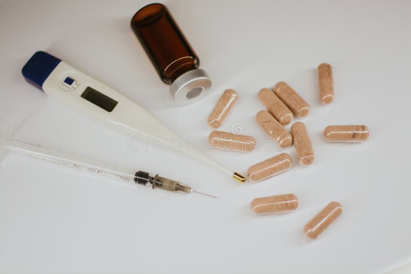 A Syringe with a Thin Sharp Needle, an Injection Ampoule, a Thermometer ...