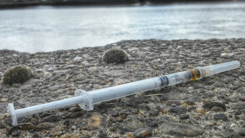 Discarded Syringe Lying Amongst Stones Stock Photo - Image of outdoors ...