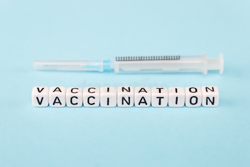 Syringe and the Word Vaccination on a Blue Background Stock Photo ...