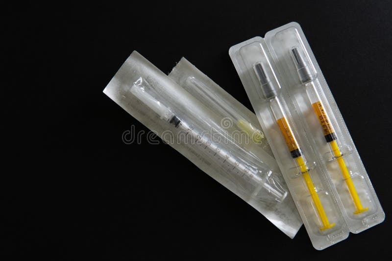 Syringes of Different Sizes on a Black Background. High Quality Photo ...