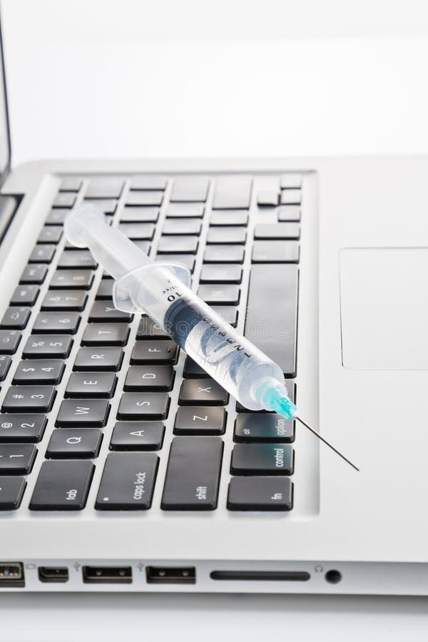 Syringes on a laptop stock photo. Image of drug, online - 21876894