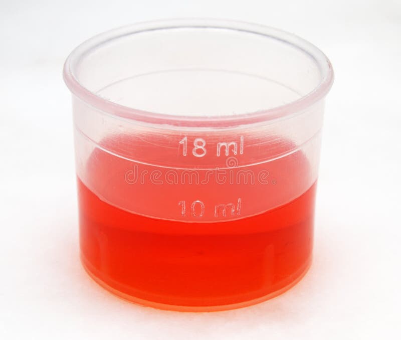 Cold or Cough Syrup Medicine in a Measuring Cup Isolated on Whit Stock ...