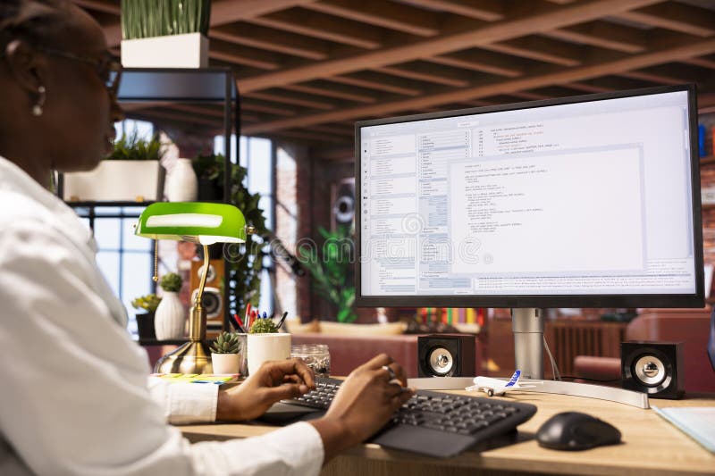 System Administrator in Apartment Office Types Code into PC, Developing ...