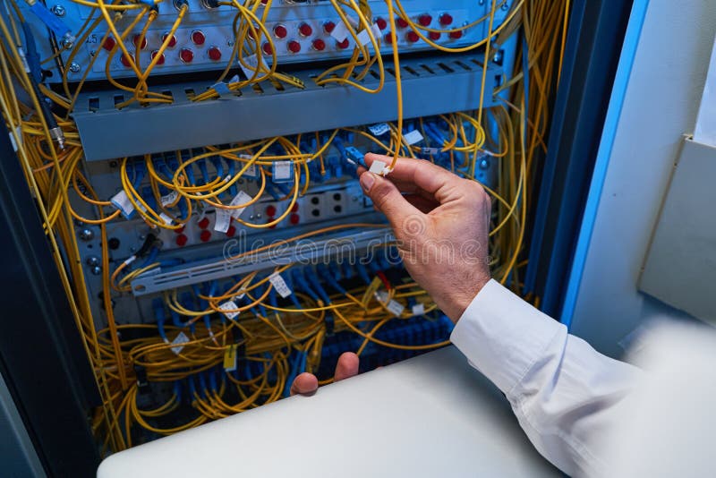 System Administrator Inserting Network Cable into Switch Stock Photo ...