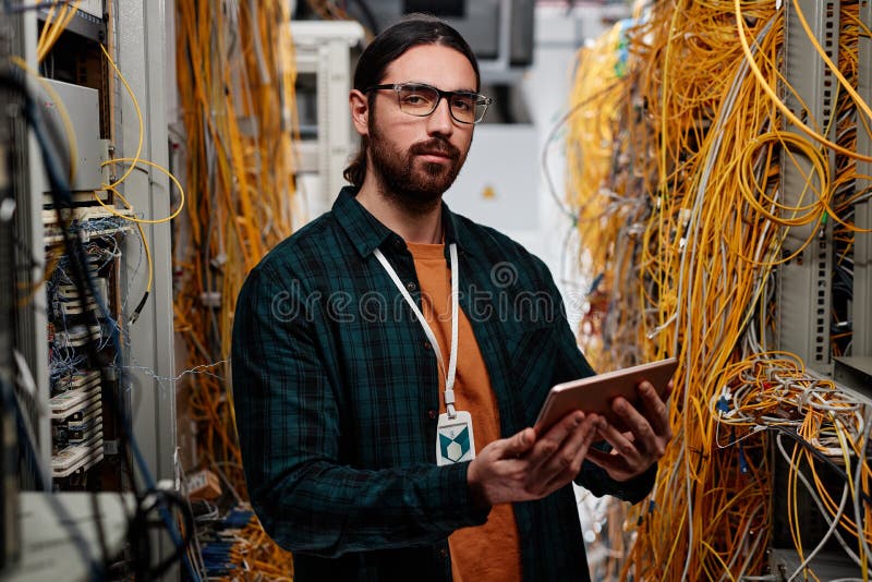 System Administrator Standing in Server Room and Looking at Camera ... System Administrator Standing in Server Room and Looking at Camera ...