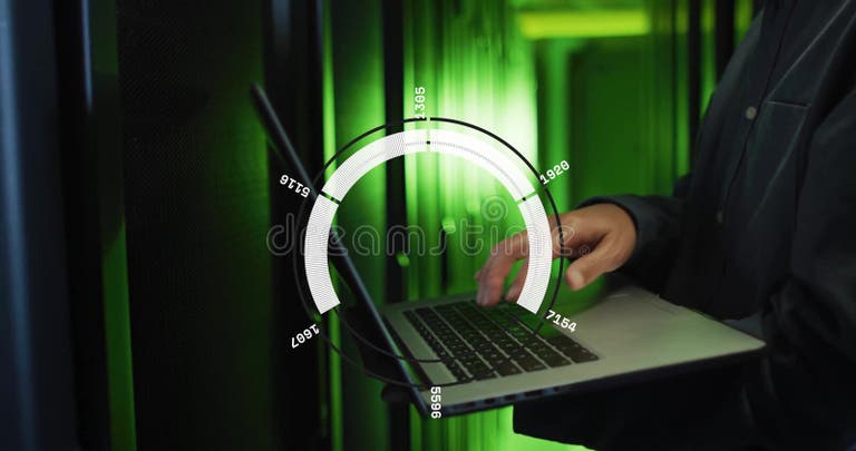 System Administrator Typing on Laptop in Data Center Server Room, with ...