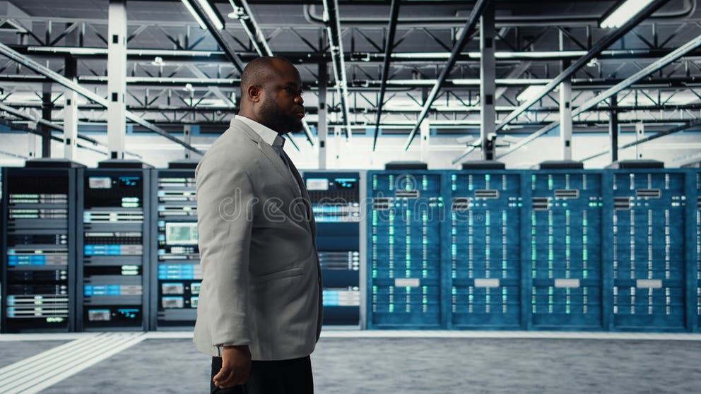 System Administrator Walking in Data Center with Rigs Doing Backups ...