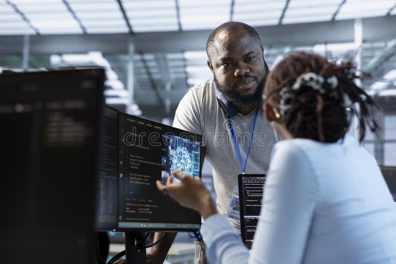 System Administrator Working with Colleague in Data Center Facility ...