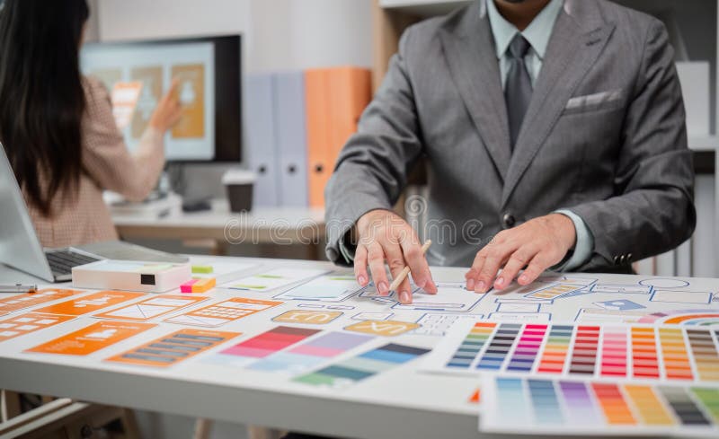 System Developer Analyzing UX UI Plans in Modern Office Setting with ...