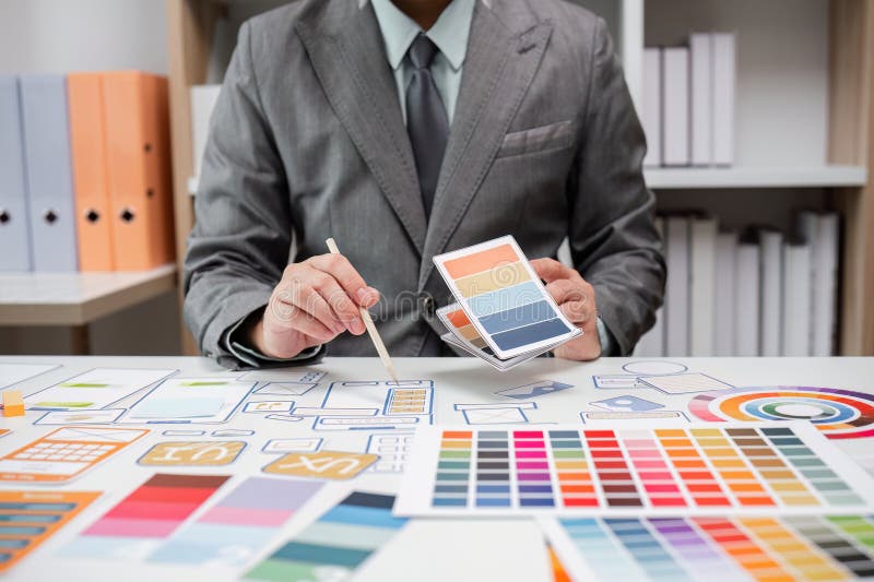 System Developer Analyzing UX UI Plans with Color Swatches and Design ...