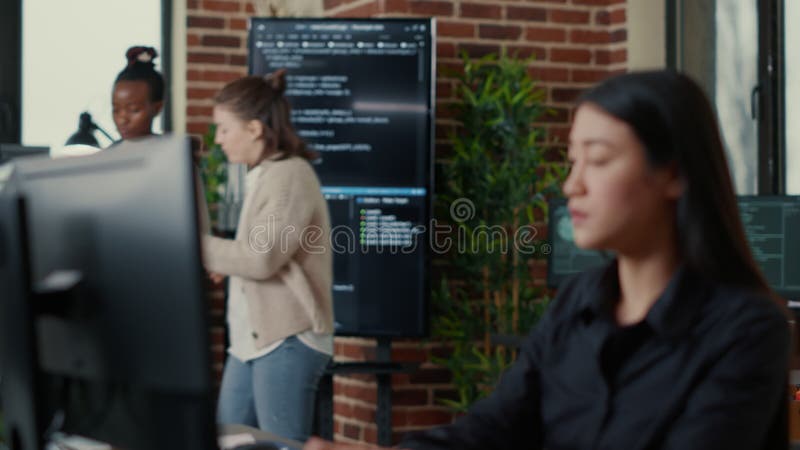 System Engineers Comparing Source Code On Wall Screen Tv Analyzing