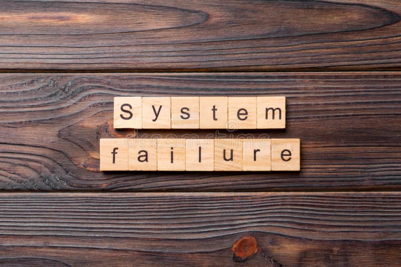 System Failure Word Written on Wood Block. System Failure Text on Table ...