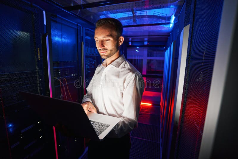 System Technician Running Diagnostic of Server Racks with Laptop Stock ...
