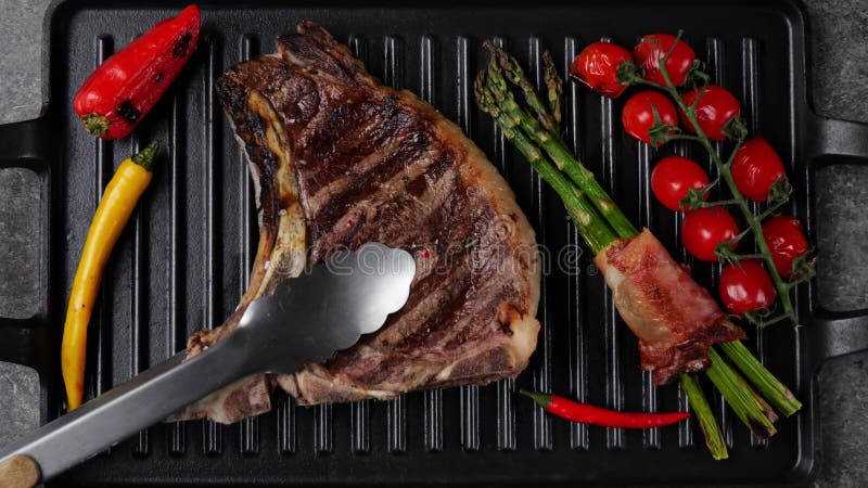 T- Bone Beef Steak Grill with Vegetables on Grill Pan. Steak Turning ...