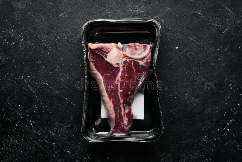 T-bone Steak in Vacuum Packaging. Market.Flat Lay Top View on Black ...