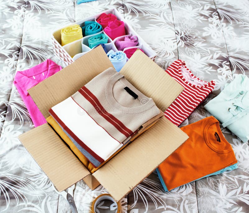 T-shirts and Delivery Box on the Bed Stock Image - Image of shipping ...