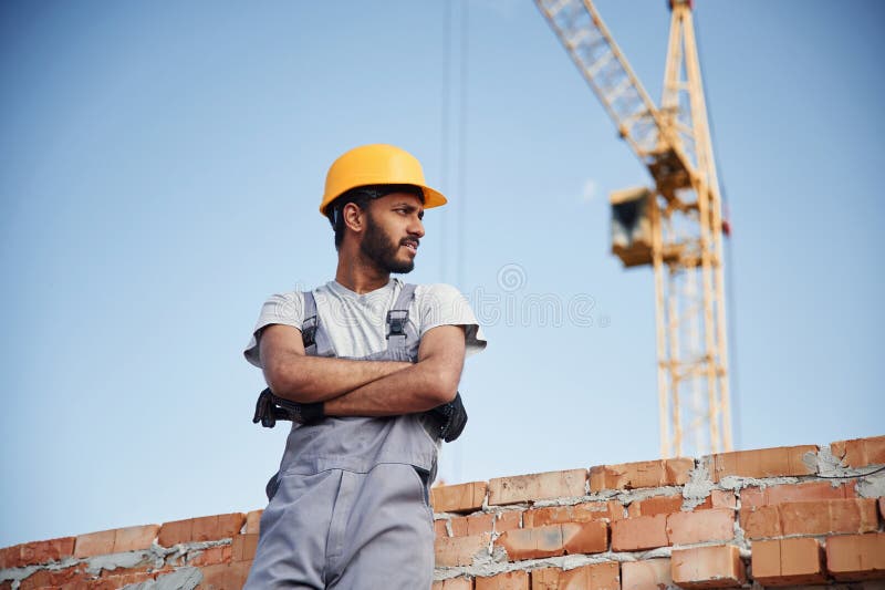 Showing and Holding Little Shovel and Brick. Handsome Indian Man is on ...