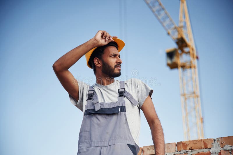 Showing and Holding Little Shovel and Brick. Handsome Indian Man is on ...