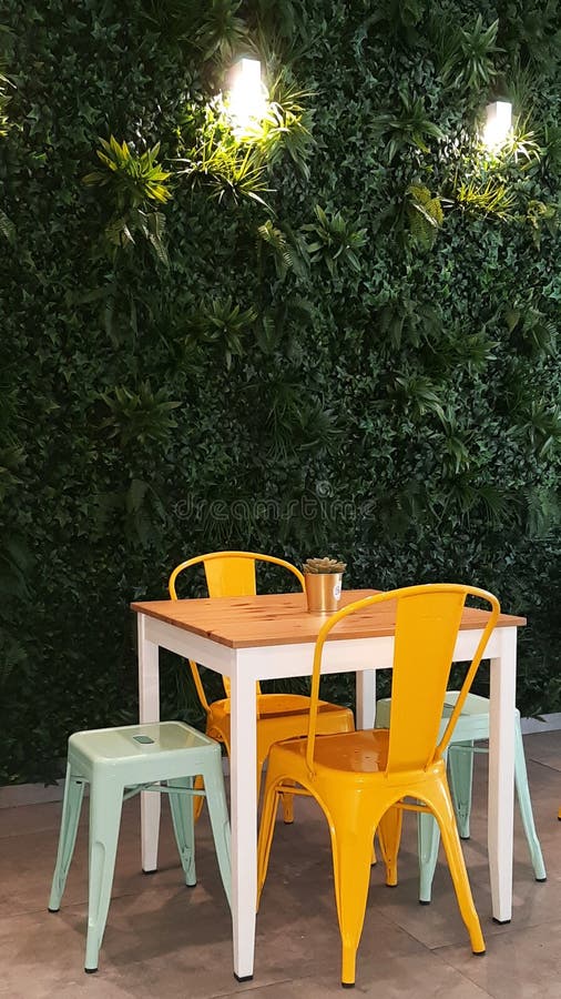 Tabke with Chairs and Plants Wall Stock Photo - Image of grass, chairs ...