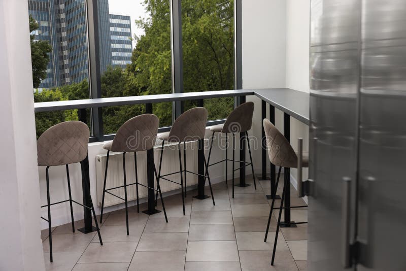Table and Bar Stools Near Window in Hostel Dining Room Stock Photo ...