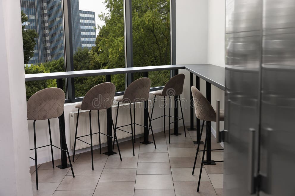 Table and Bar Stools Near Window in Hostel Dining Room Stock Photo ...