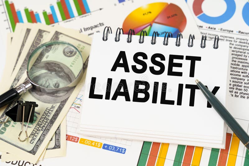 On the Table are Business Charts, Dollars and a Notepad with the ...