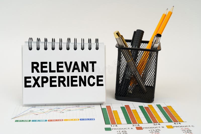 On the Table are Business Charts, Office Supplies and a Notepad with ...