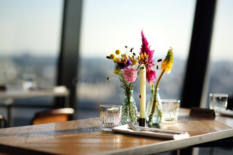 Table in a Cafe or Restaurant with Flowers in a Vase and a Candle ...