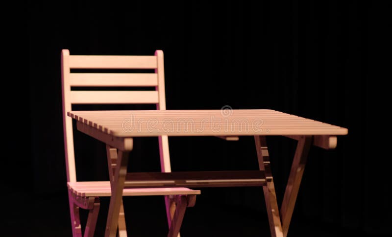 Table Chair on a Black Background in a Theater Stock Photo - Image of ...