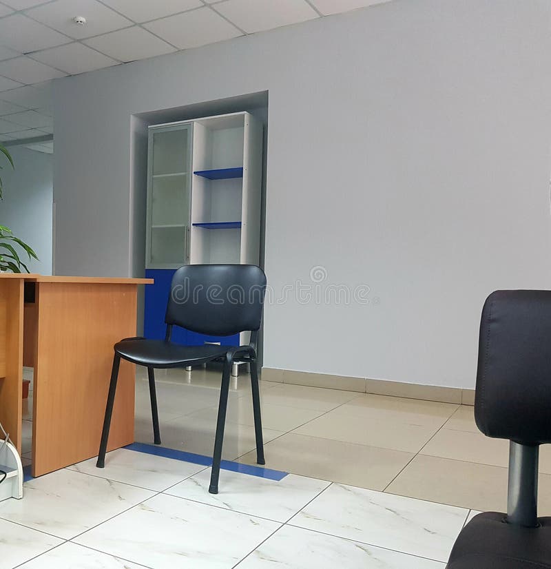 A Table, Chairs and an Empty Office Cabinet in a Room without People ...