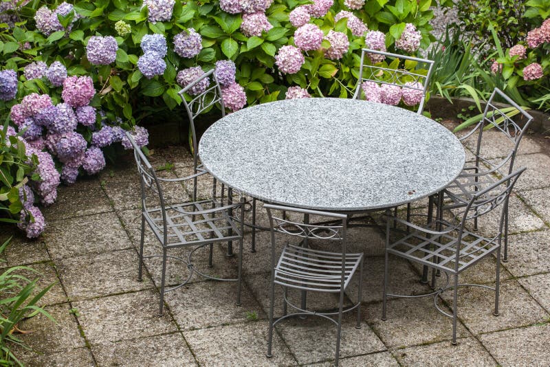 Table and Chairs in Garden with Color Hydrangea Stock Photo - Image of ...