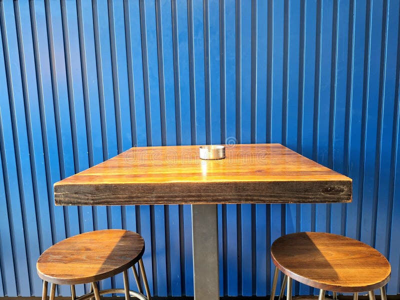 Table and Chairs with Minimalist Blue Wallpaper Stock Image - Image of ...