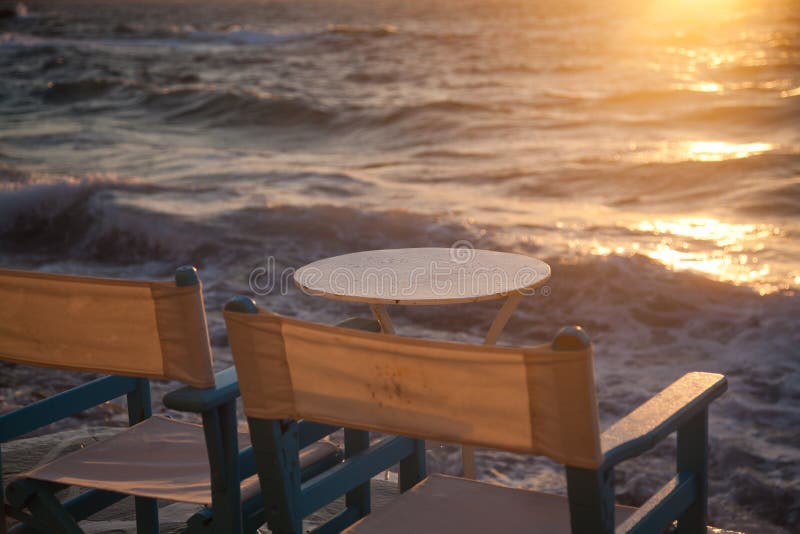 Table and Chairs Near the Waves at Sunset - Beach Holiday Stock Image ...