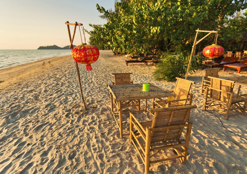 Table and Chairs on a Tropical Beach with Sunset Views Stock Photo ...