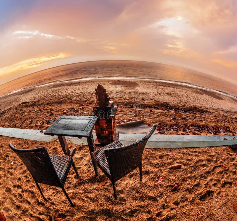 Table and Chairs on a Tropical Beach with Sunset Views Stock Photo ...