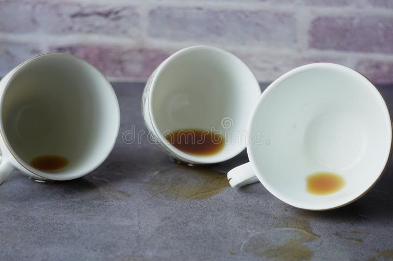 The Table is Cluttered with Empty Coffee Cups, Each Still Holding a Few ...