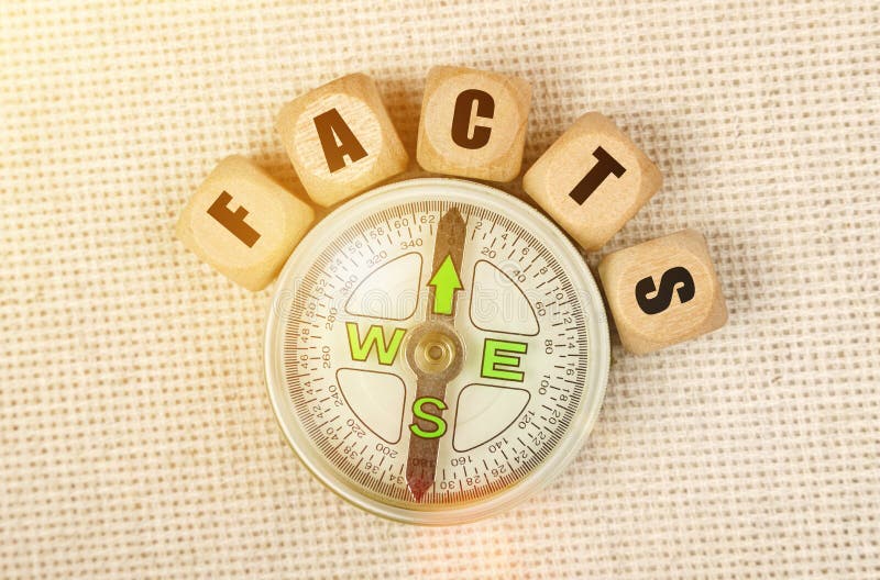 On the Table is a Compass and Cubes with the Inscription - FACTS Stock ...