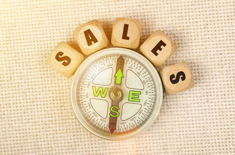 On the Table is a Compass and Cubes with the Inscription - SALES Stock ...