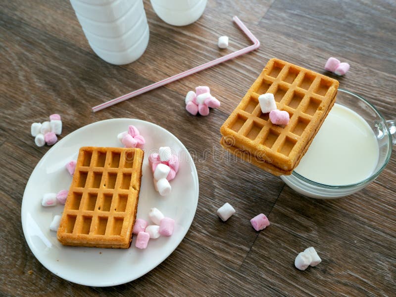 On the Table is a Cup of Milk or a Milk Drink. on a Cup of Cookies ...