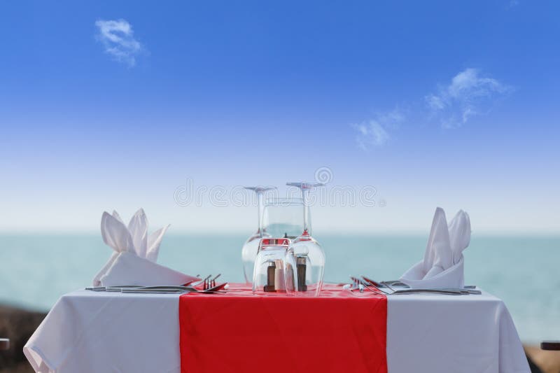 Dinner table beside beach stock image. Image of napkin - 29966033