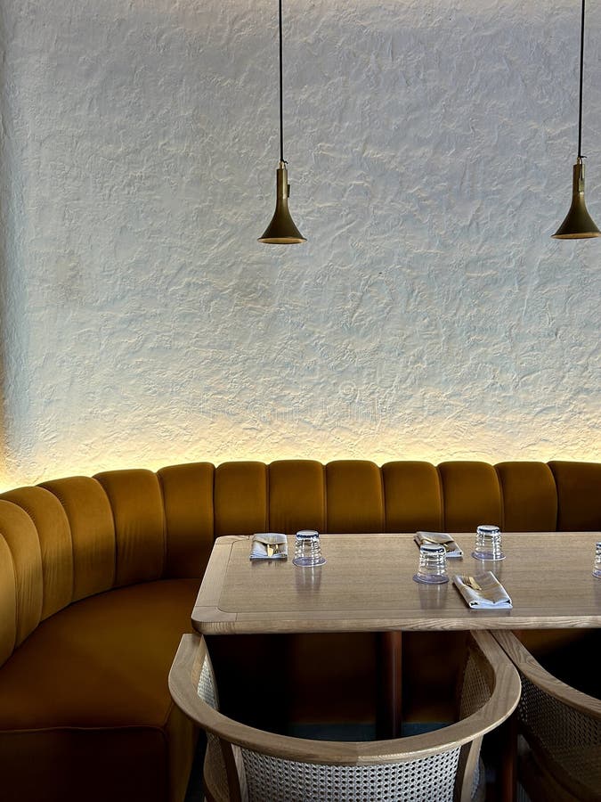 Table in Front of Sofa and White Wall in Restaurant Stock Photo - Image ...