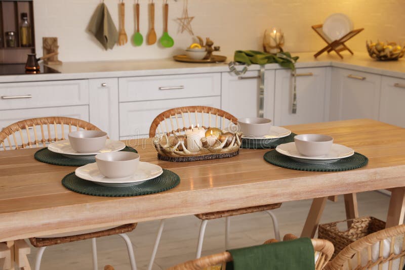 Table with Dishware in Beautiful Kitchen Decorated for Christmas ...