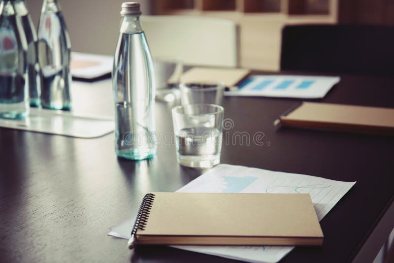 Table with Documents and Bottle of Water Prepared for Business Meeting ...