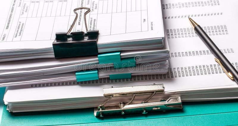 On the Table are Documents Fastened with Clips, a Pen and a Folder with ...