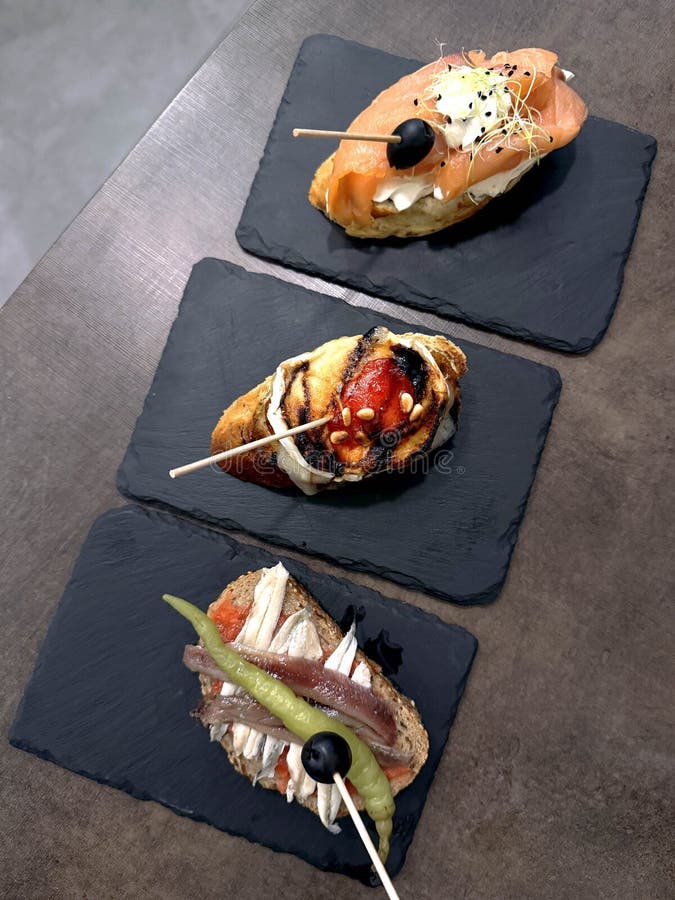 A Table is Elegantly Set with Black Slate Plates, Offering a Variety of ...