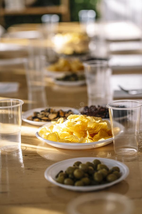 Table with Food To Have an Aperitif with Plastic Glasses and Plates ...