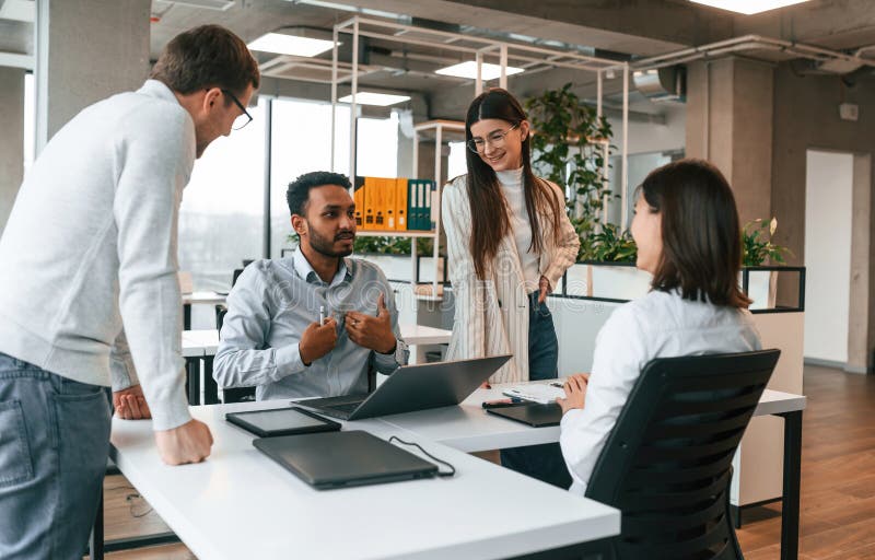 By the Table. Four People are Working in the Office Together Stock ...